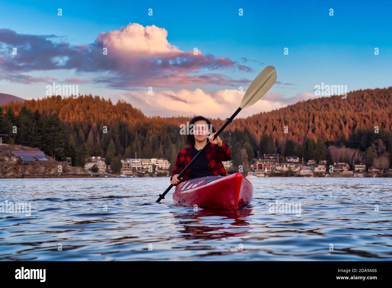 Adventurous Girl Paddling on a Bright Red Kayak Stock Photo - Alamy