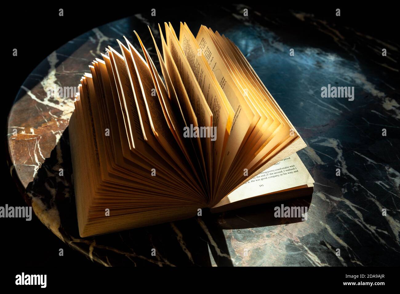 An open book with its pages turning Stock Photo - Alamy