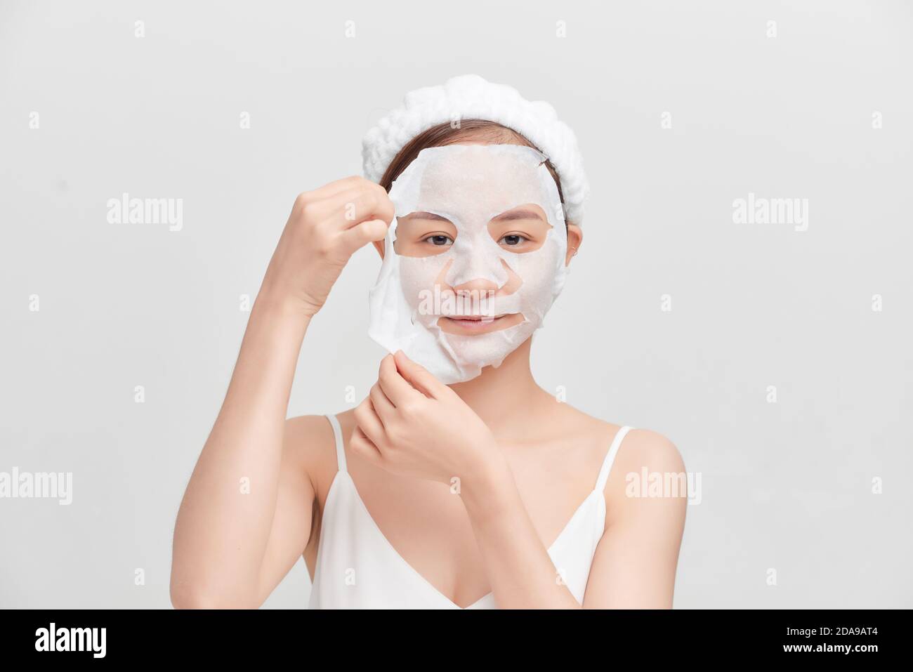 Young Asian woman removing her cosmetic mask Stock Photo - Alamy