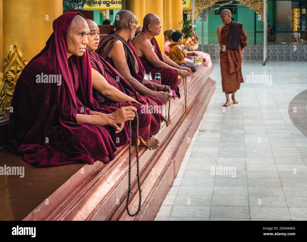 yangon myanmar Pagoda Shwedagon monk praying with orange robe and ...