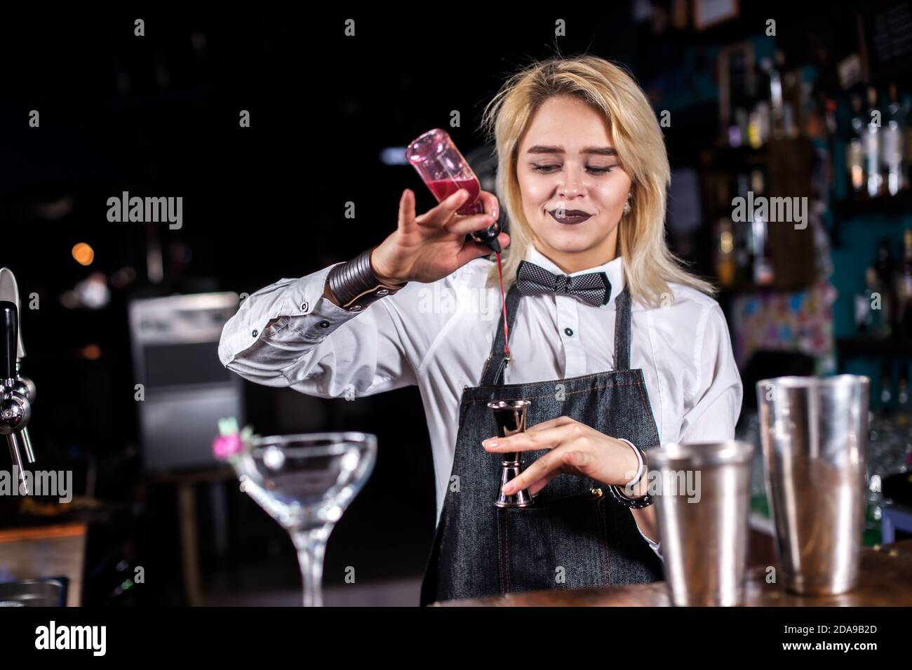 Charming woman bartending mixes a cocktail at the nightclub Stock Photo ...