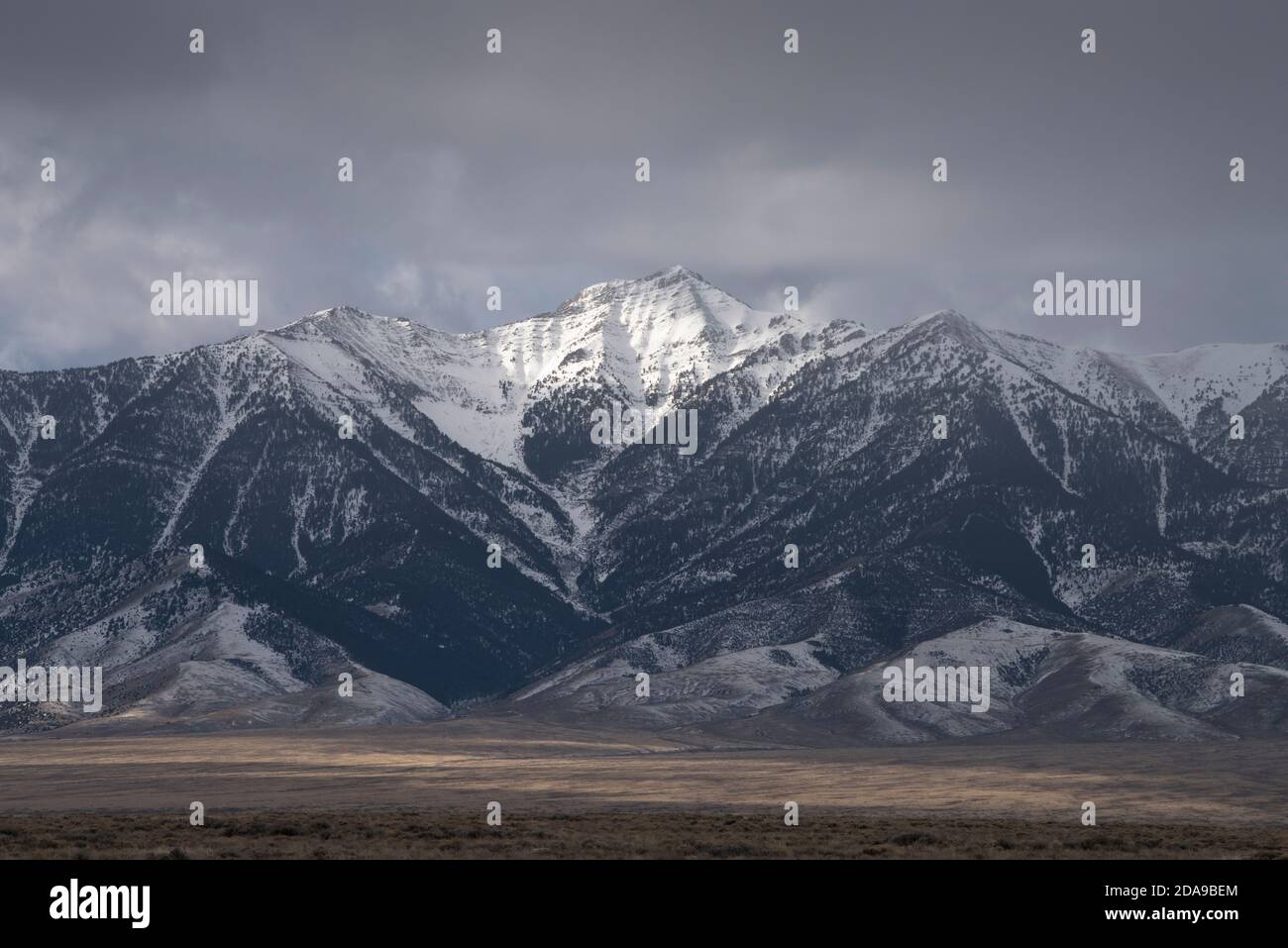 Sun paints the peak of Saddle Mountain through spring-time storm clouds ...