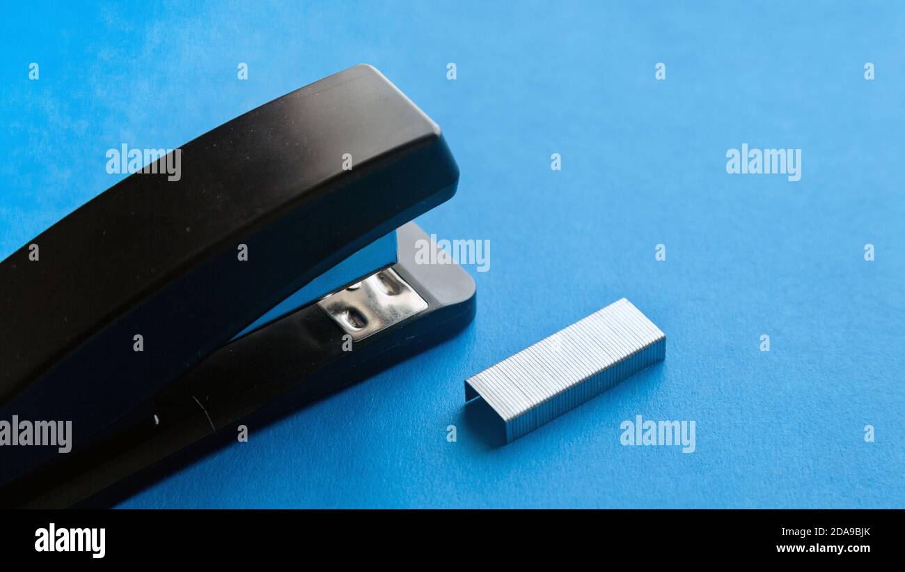 A set of office supplies. Stapler and staples blue background Stock ...