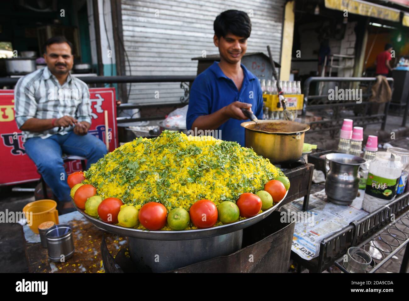 Jaipur, India. May 10, 2017. Indian man selling street food Poha or ...