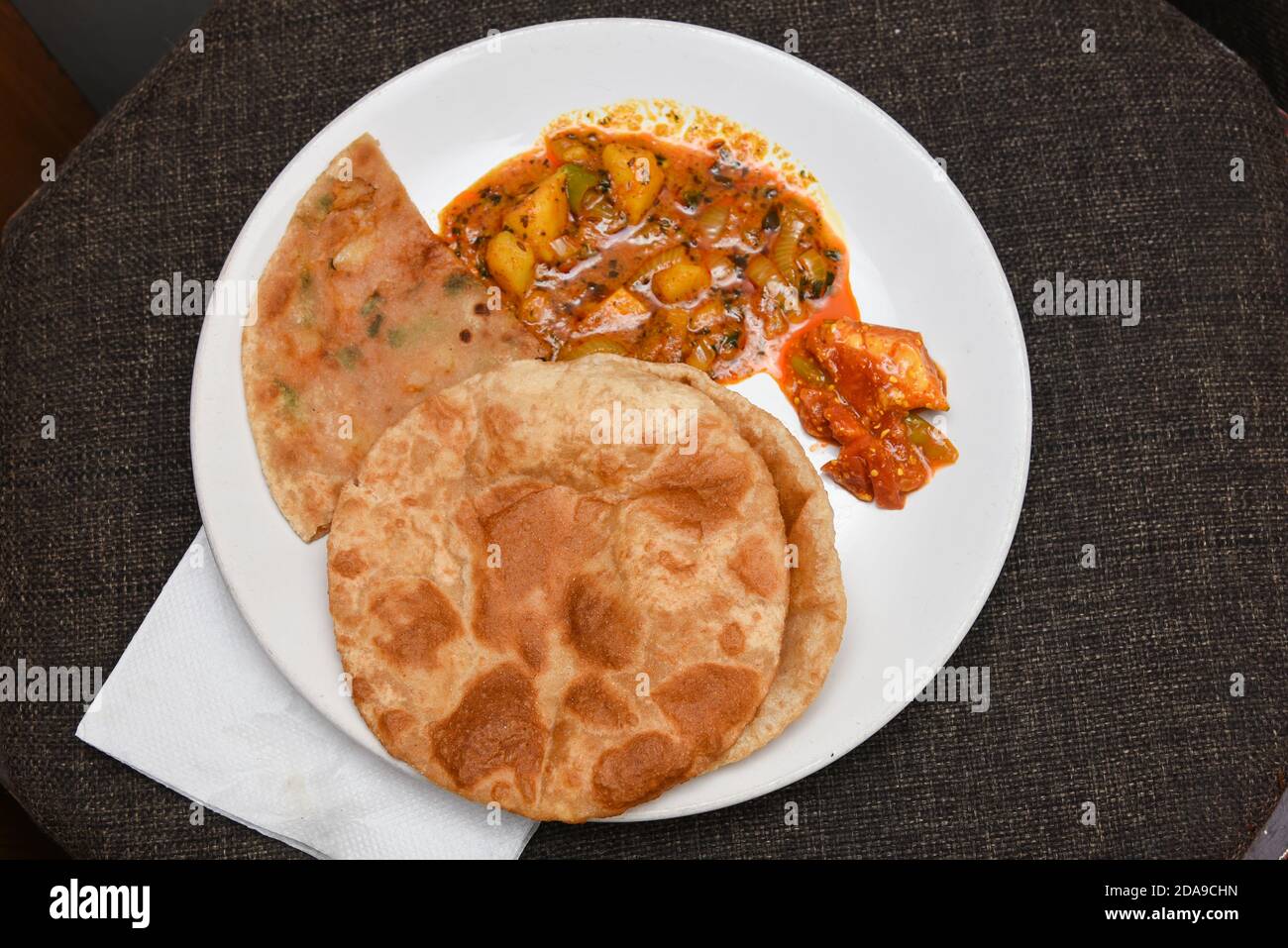 Top view of Bedmi puri / Poori, methi paratha with aloo ki sabzi potato ...