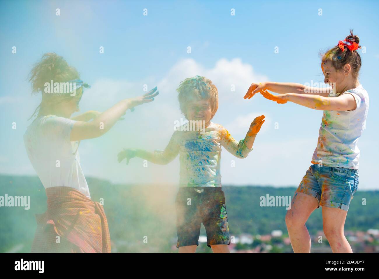 Group of happy children outdoor. Colored splash powder and color dust ...