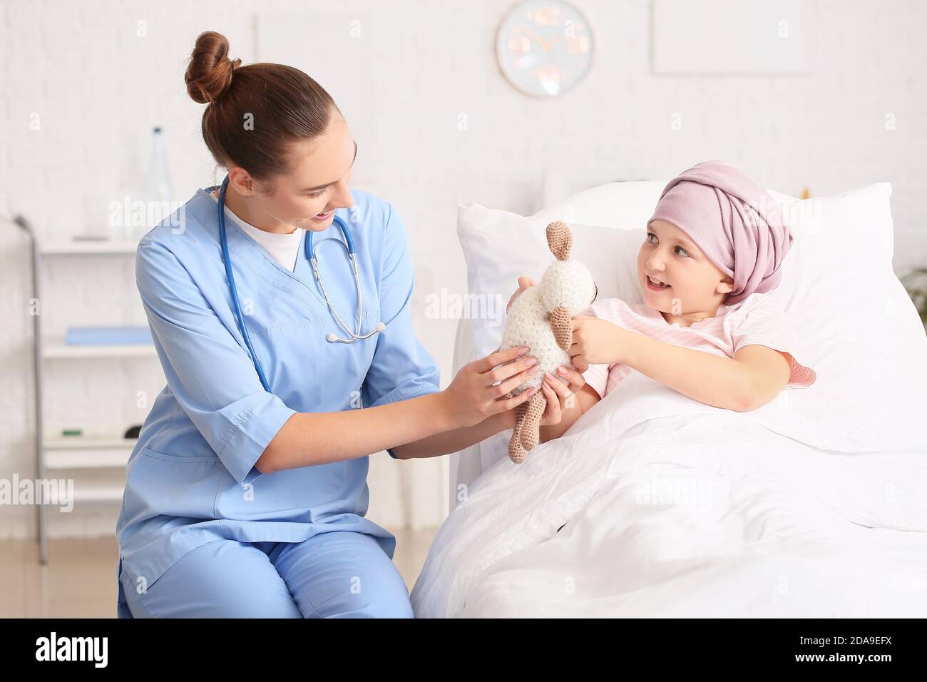 Nurse and little girl undergoing course of chemotherapy in clinic Stock ...