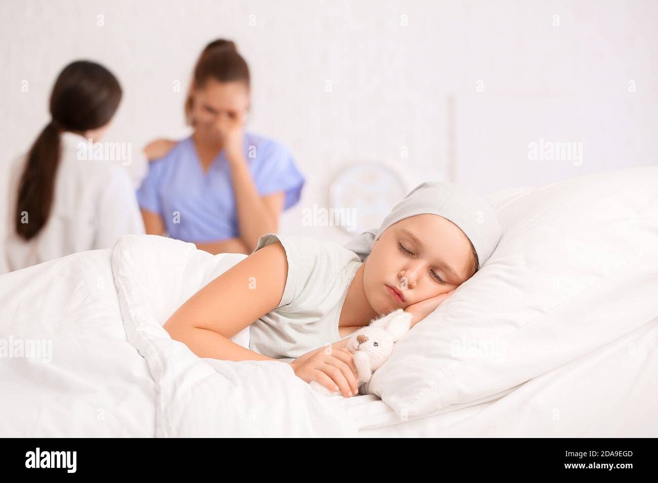 Little girl after chemotherapy in clinic. Childhood cancer awareness ...