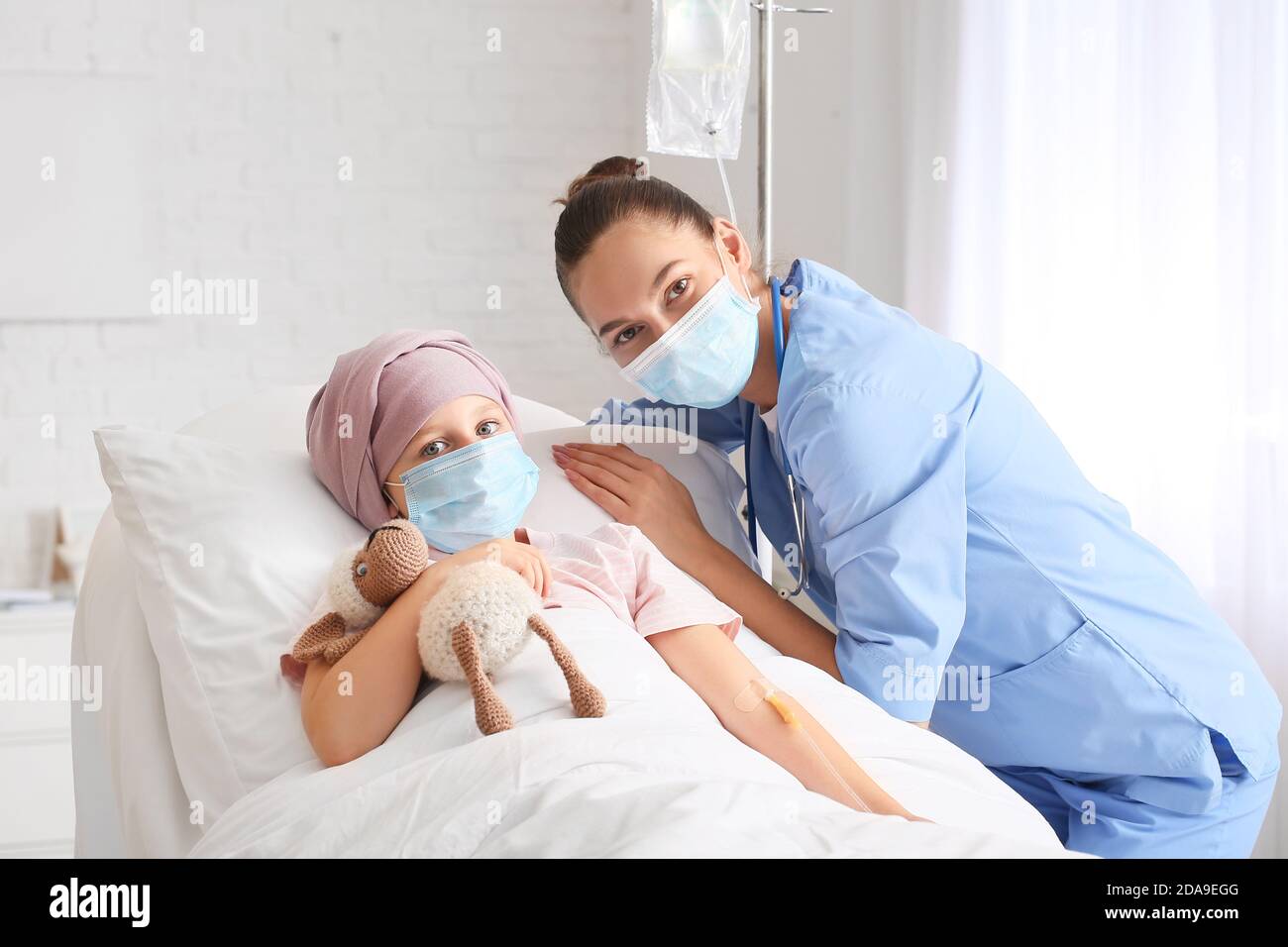 Nurse and little girl undergoing chemotherapy course in clinic Stock ...