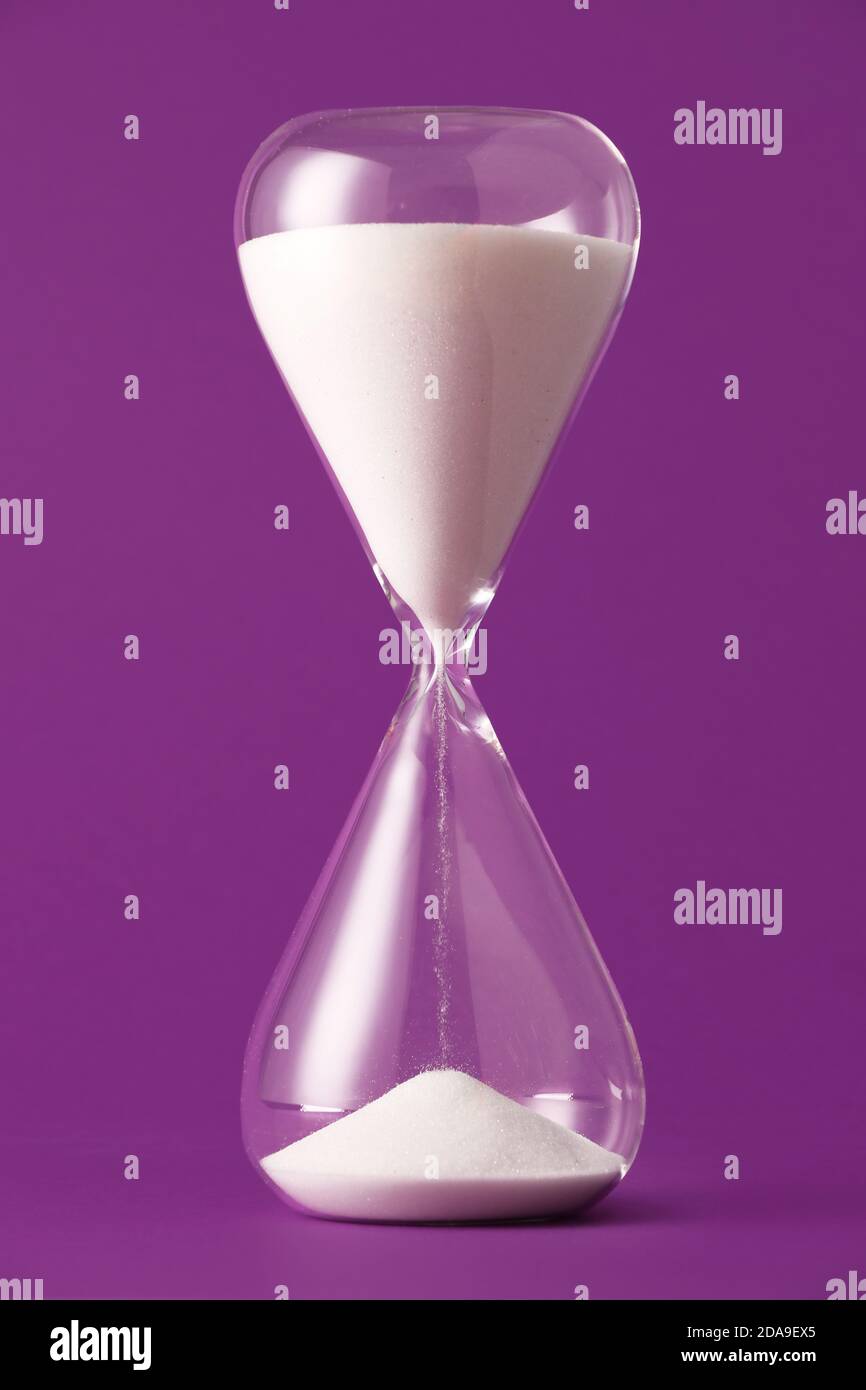 Hourglass on color background. Time management concept Stock Photo - Alamy