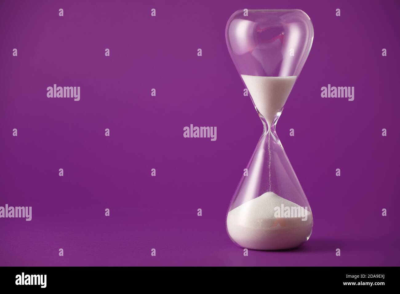Hourglass on color background. Time management concept Stock Photo - Alamy