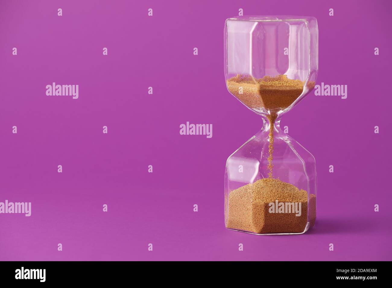 Hourglass on color background. Time management concept Stock Photo - Alamy