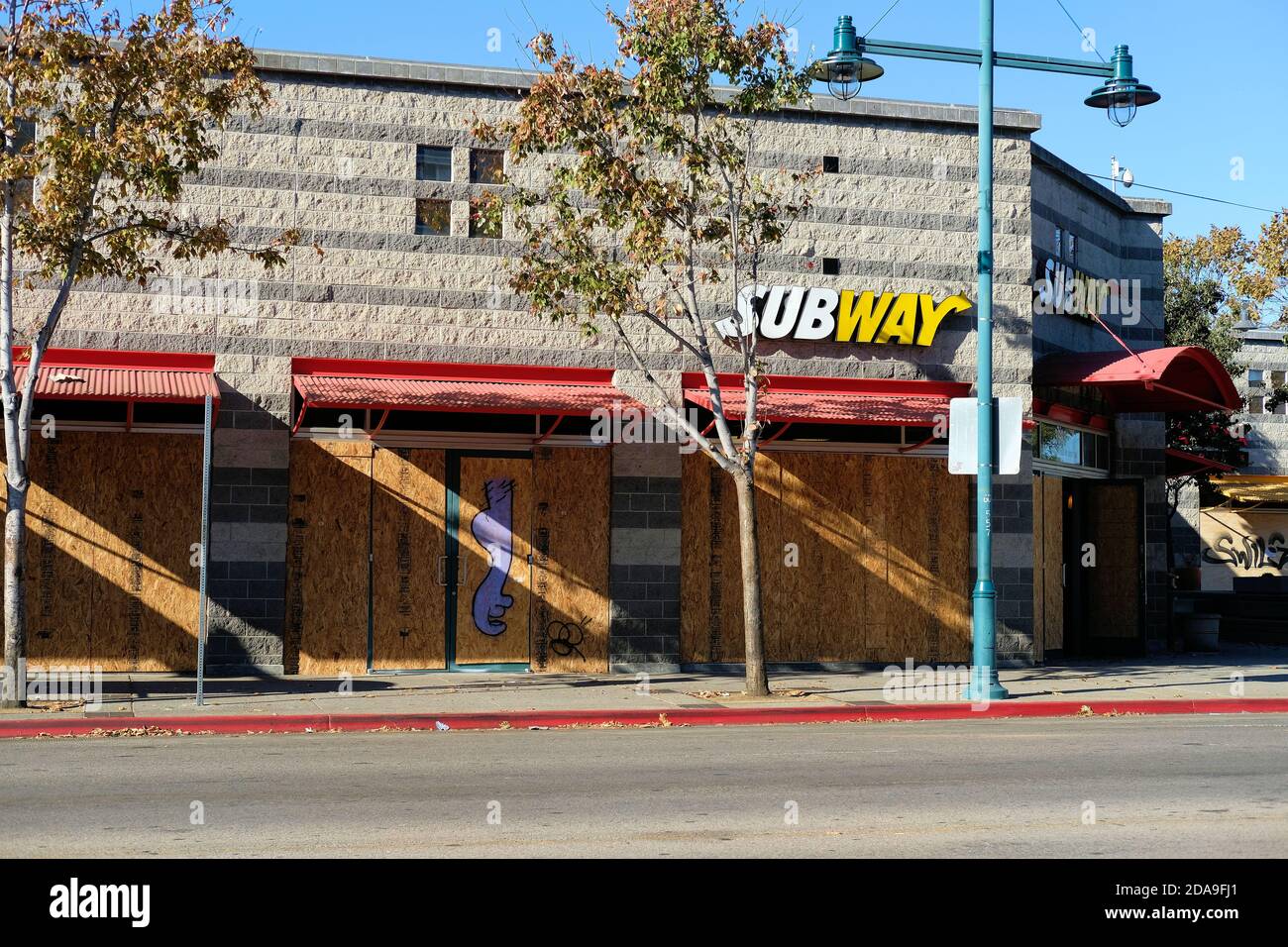 A Subway sandwich restaurant boarded up with plywood in anticipation of ...