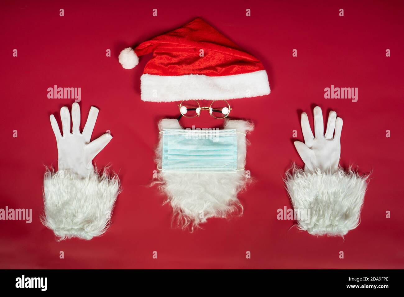 Santa Claus head with surgical mask, hat, white beard and gloves on red ...
