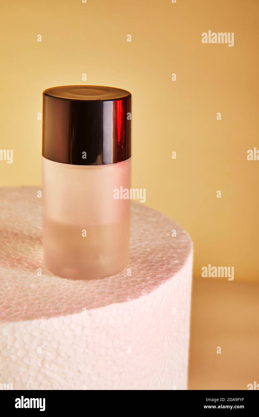 Harvesting perfume bottles without labels on a white podium Stock Photo ...