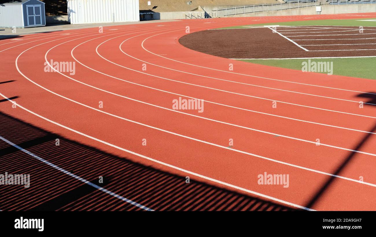 Empty lanes at a track field on a sunny day; competitive running for ...