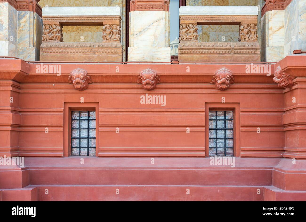 Two adjacent wrought iron grid windows installed in ornamental wall ...