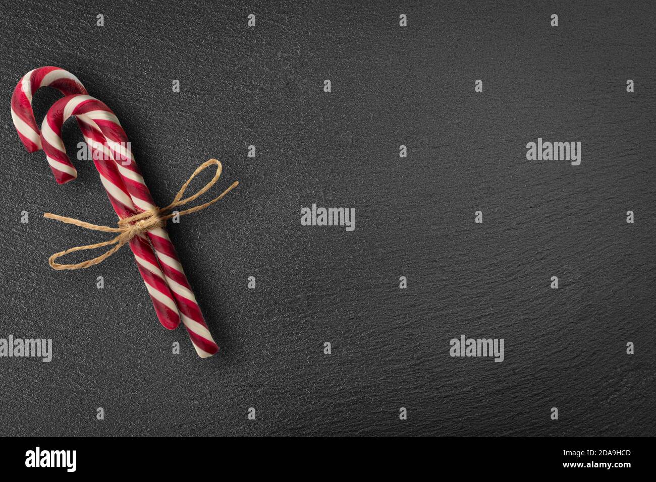 Christmas card with candy canes. Candy Canes On Black Stone. Christmas ...