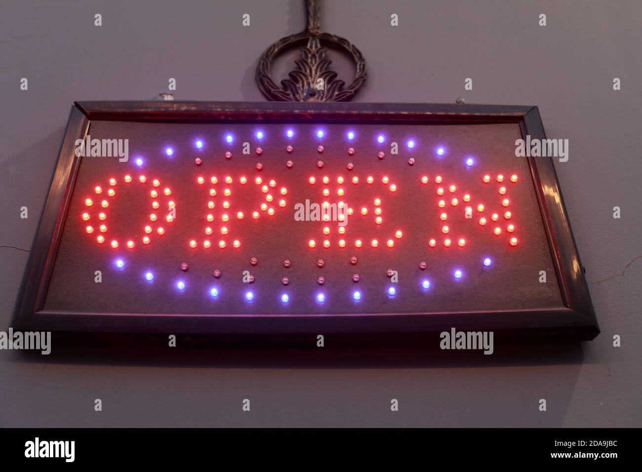 Glowing sign open on wall in restaurant Stock Photo - Alamy