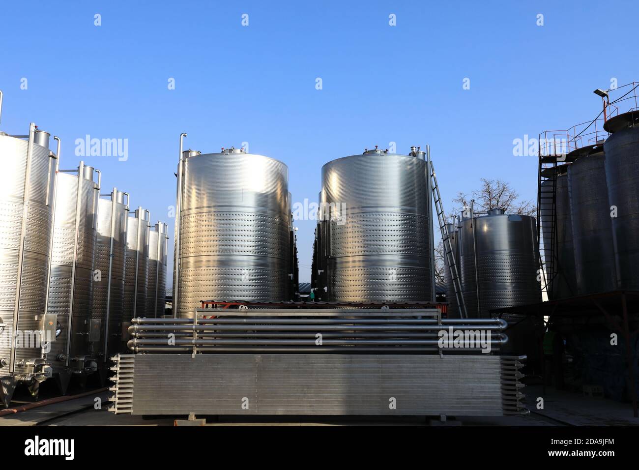 View of outdoor steel tanks in winery Stock Photo - Alamy