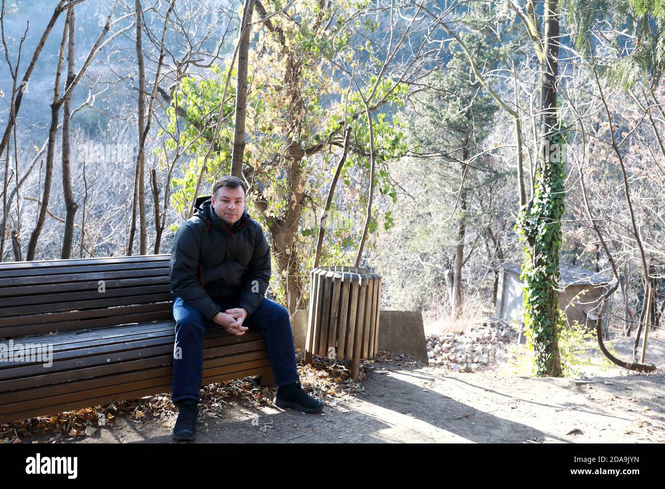 Man resting on bench in botanical garden of Tbilisi Stock Photo - Alamy