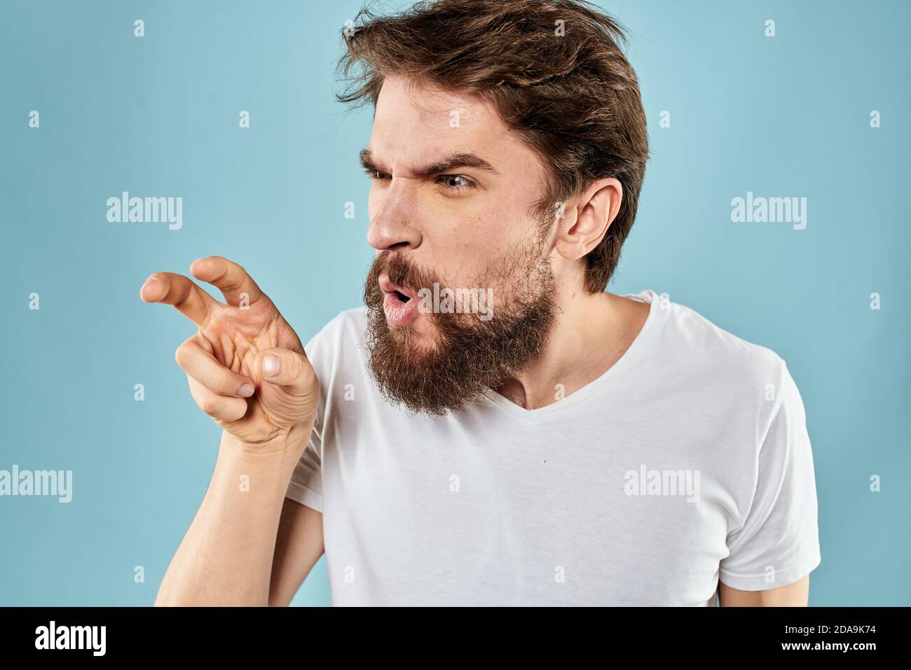Man with disgruntled facial expression gesturing with hands studio ...