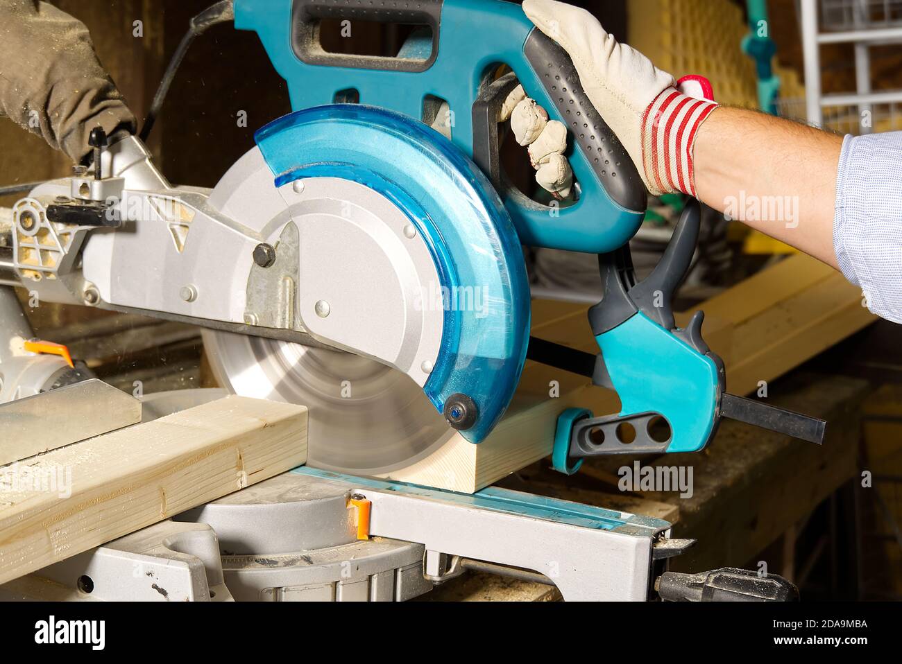 Carpenter work with circular saw for cutting wood bar, the man sawed ...