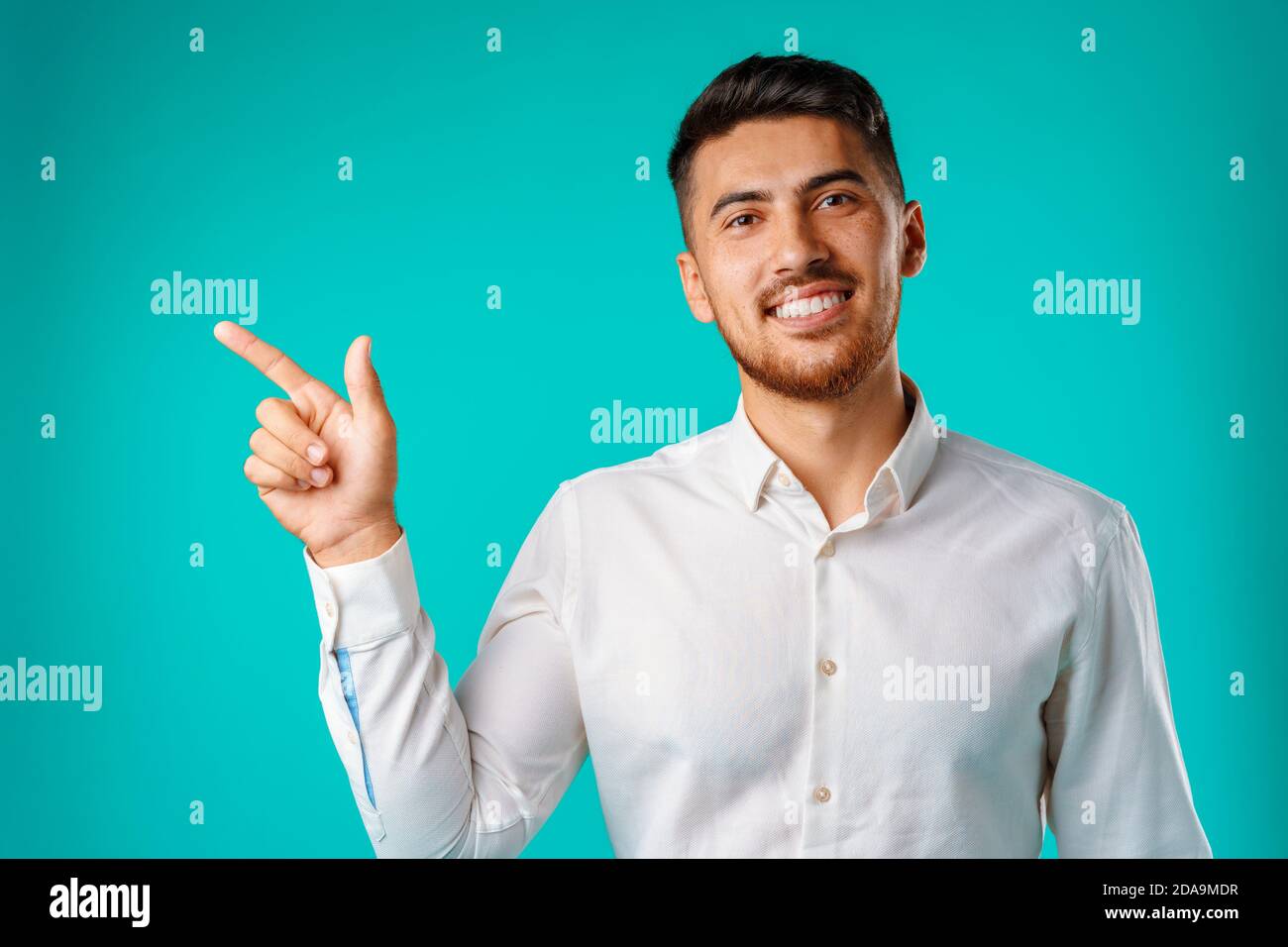 Young handsome man standing and pointing fingers to the side Stock ...