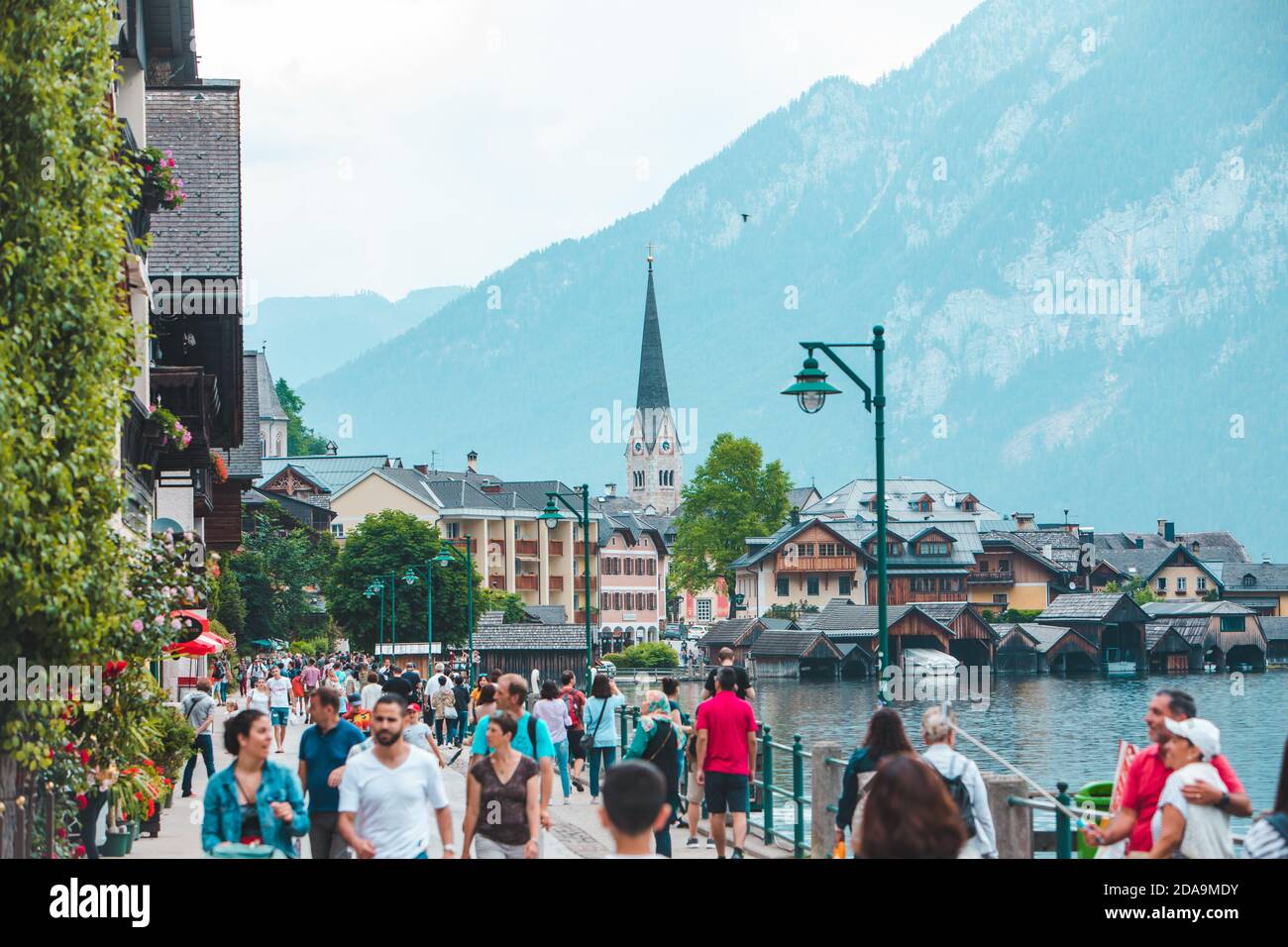 Hallstatt, Austria - June 15, 2019: people walking by city quay ...