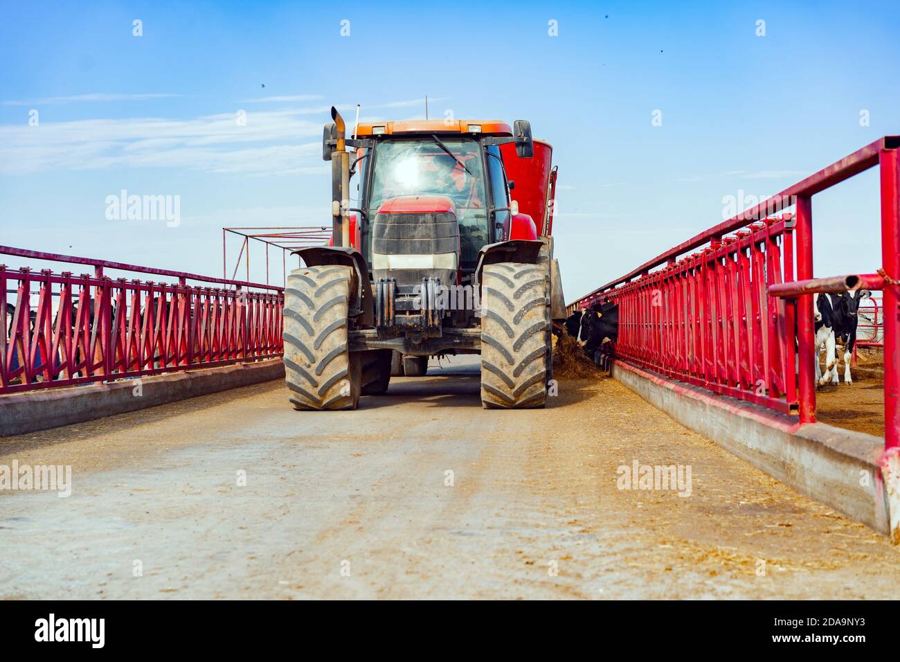 Modern red agricultural tractor in a farm Stock Photo - Alamy