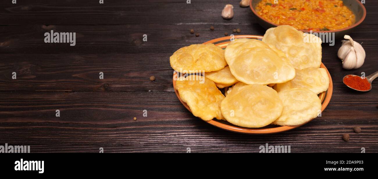 Indian cuisine. Luchi tortillas with cooked and fresh vegetables, Halwa ...