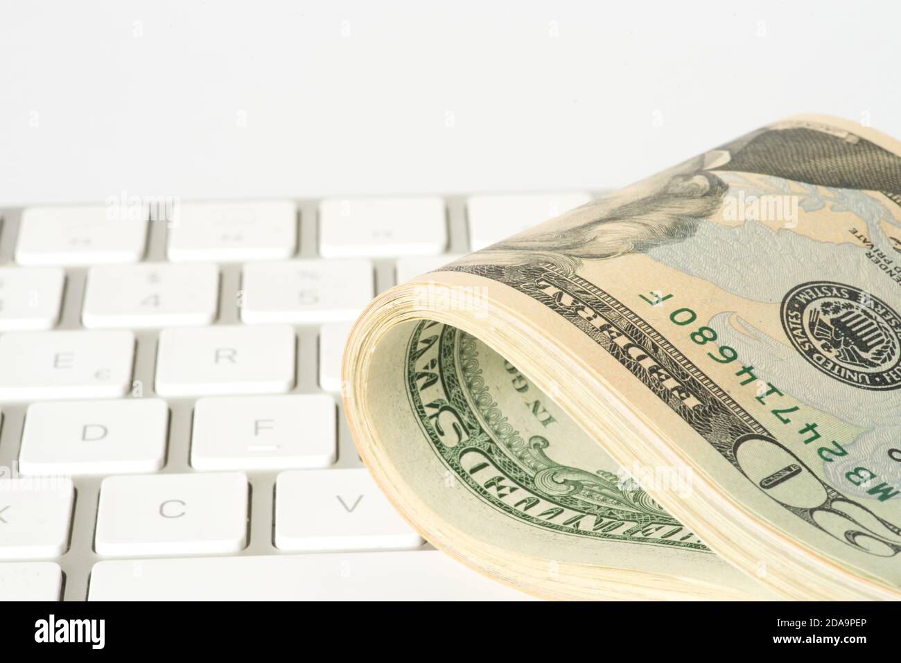Dollar bills and a computer Stock Photo - Alamy