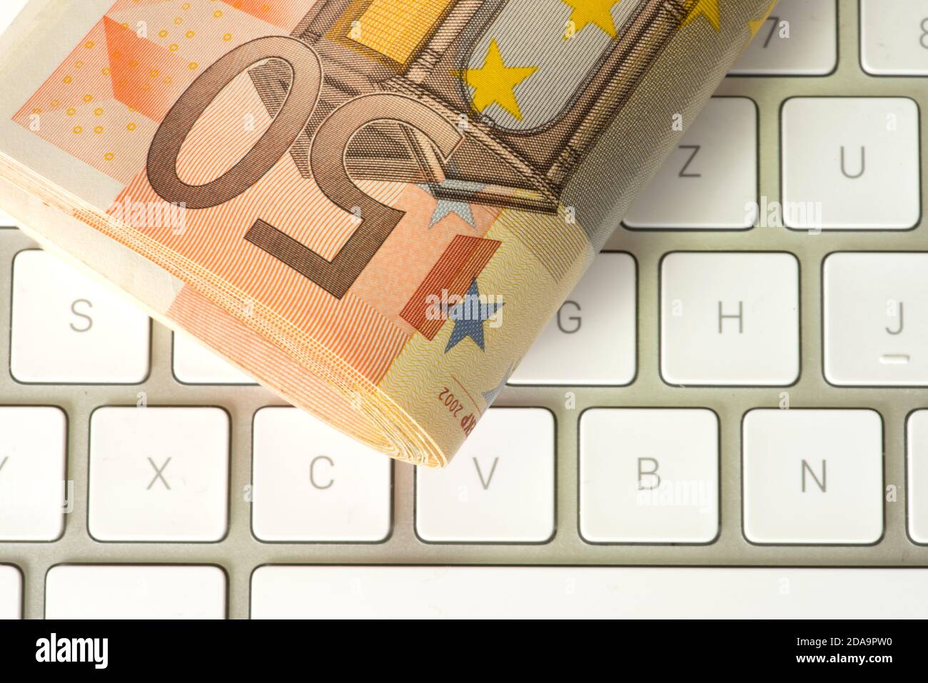 Euro banknotes and a computer Stock Photo - Alamy