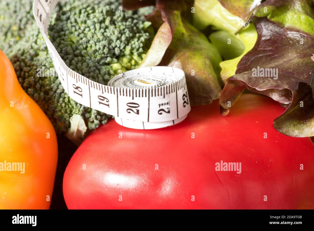 A measuring tape and various vegetables for a diet Stock Photo - Alamy