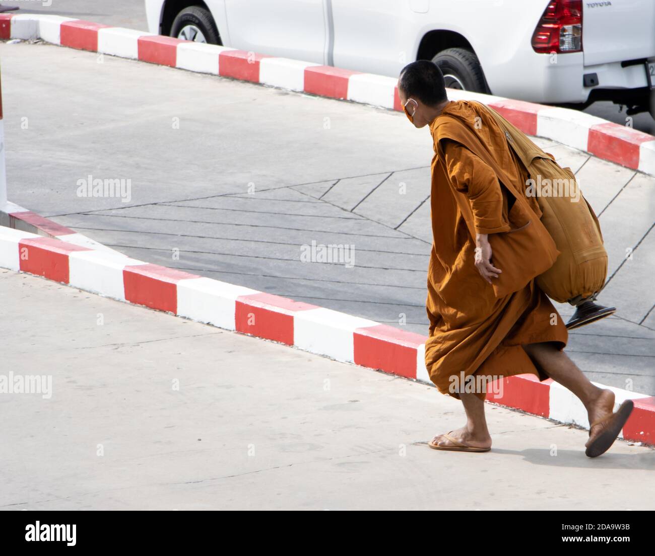 Old monk walking on street hi-res stock photography and images - Alamy