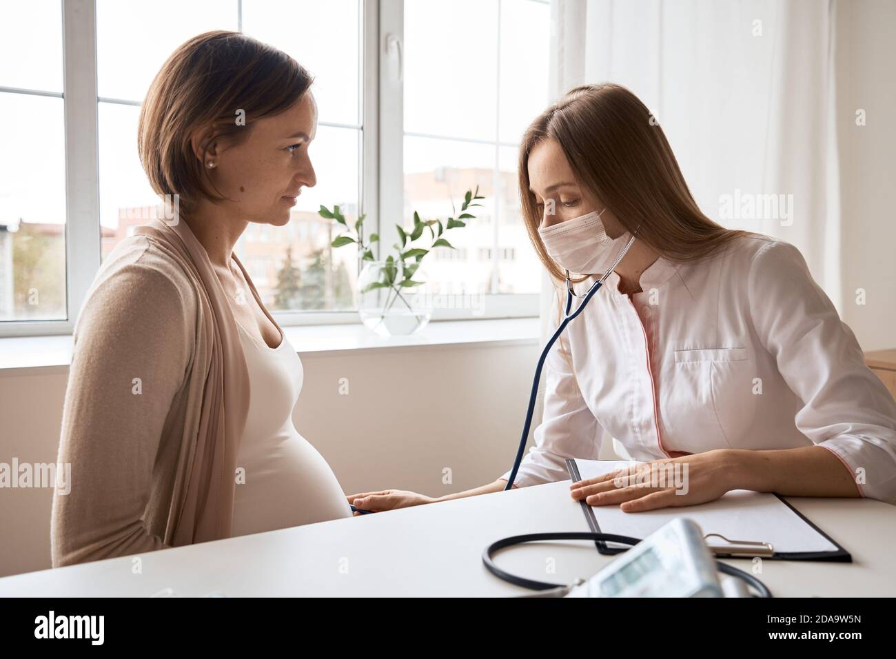 Happy pregnant woman visit gynecologist doctor at hospital or medical clinic for pregnancy ...