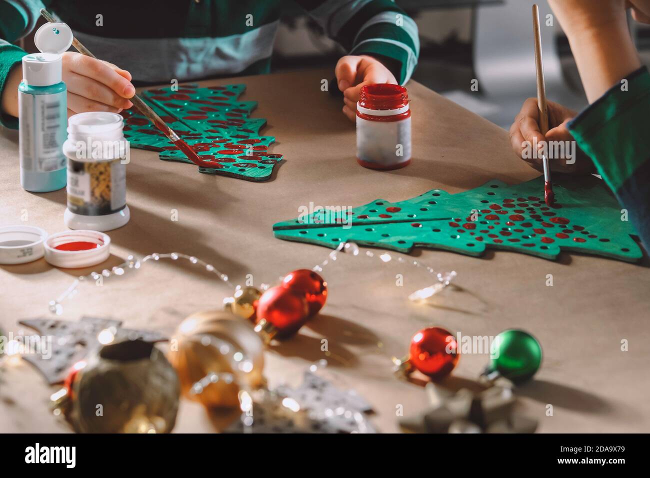 Two little kids making christmas decorations and postcards and painting ...