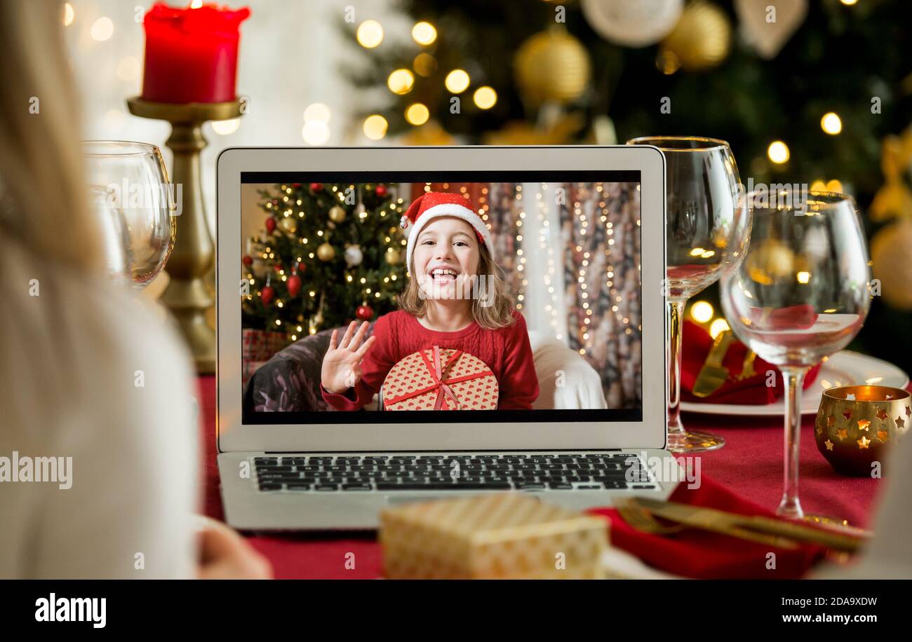 A happy family with a child is celebrating Christmas with their friends ...