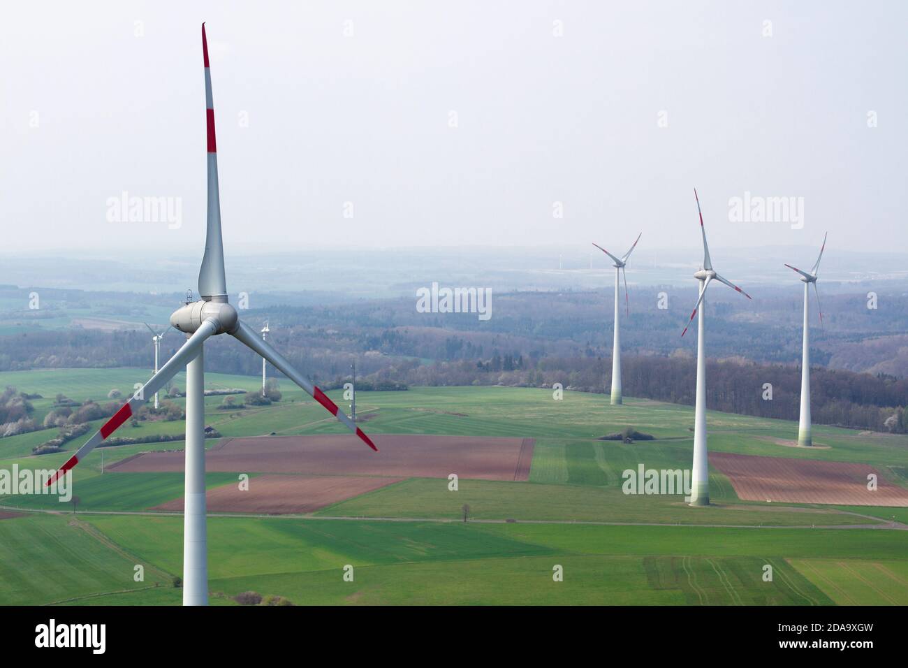 wind turbine, wind farm on a sunny misty morning shot from eye level ...
