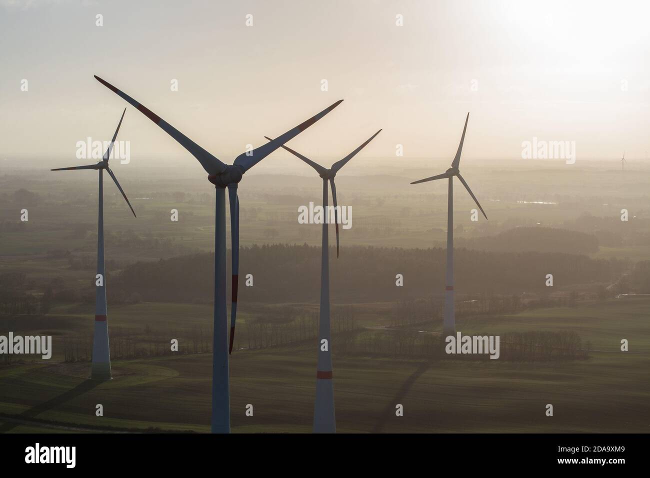 wind turbine, wind farm on a sunny misty morning shot from eye level ...
