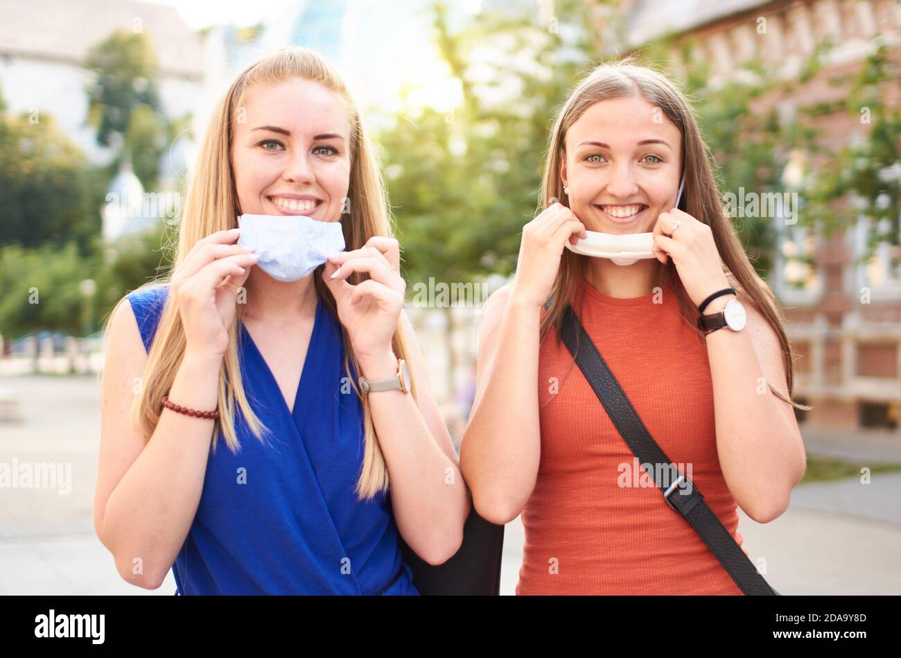 Young millennial friends with face mask after lockdown reopen - New ...