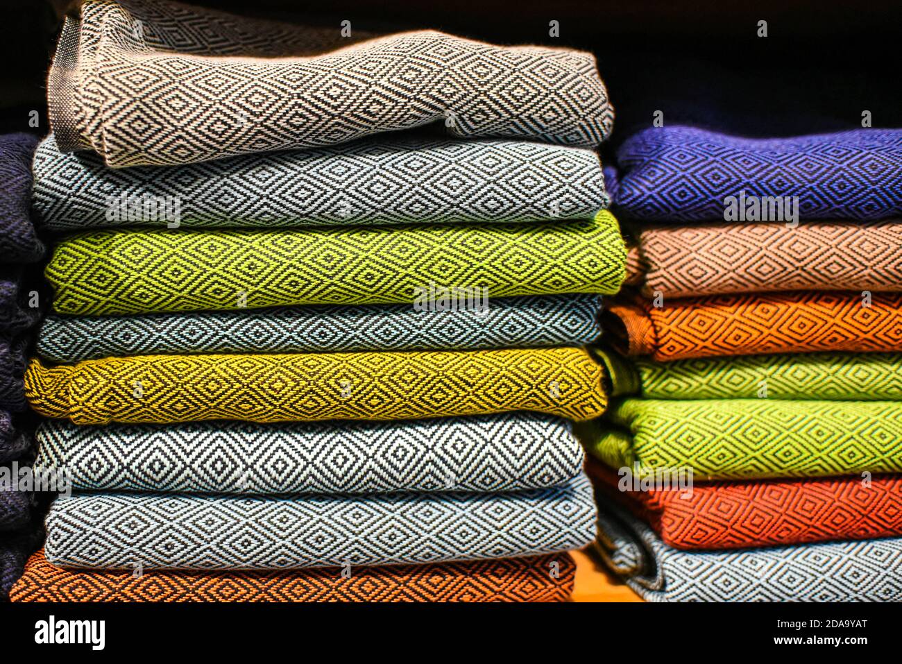 stacked in the closet on the shelf colorful fabric clothes Stock Photo ...