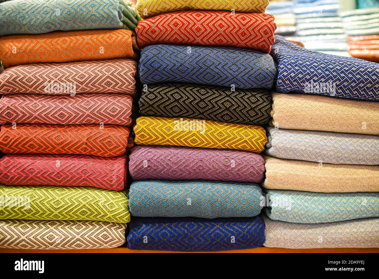 stacked in the closet on the shelf colorful fabric clothes Stock Photo ...