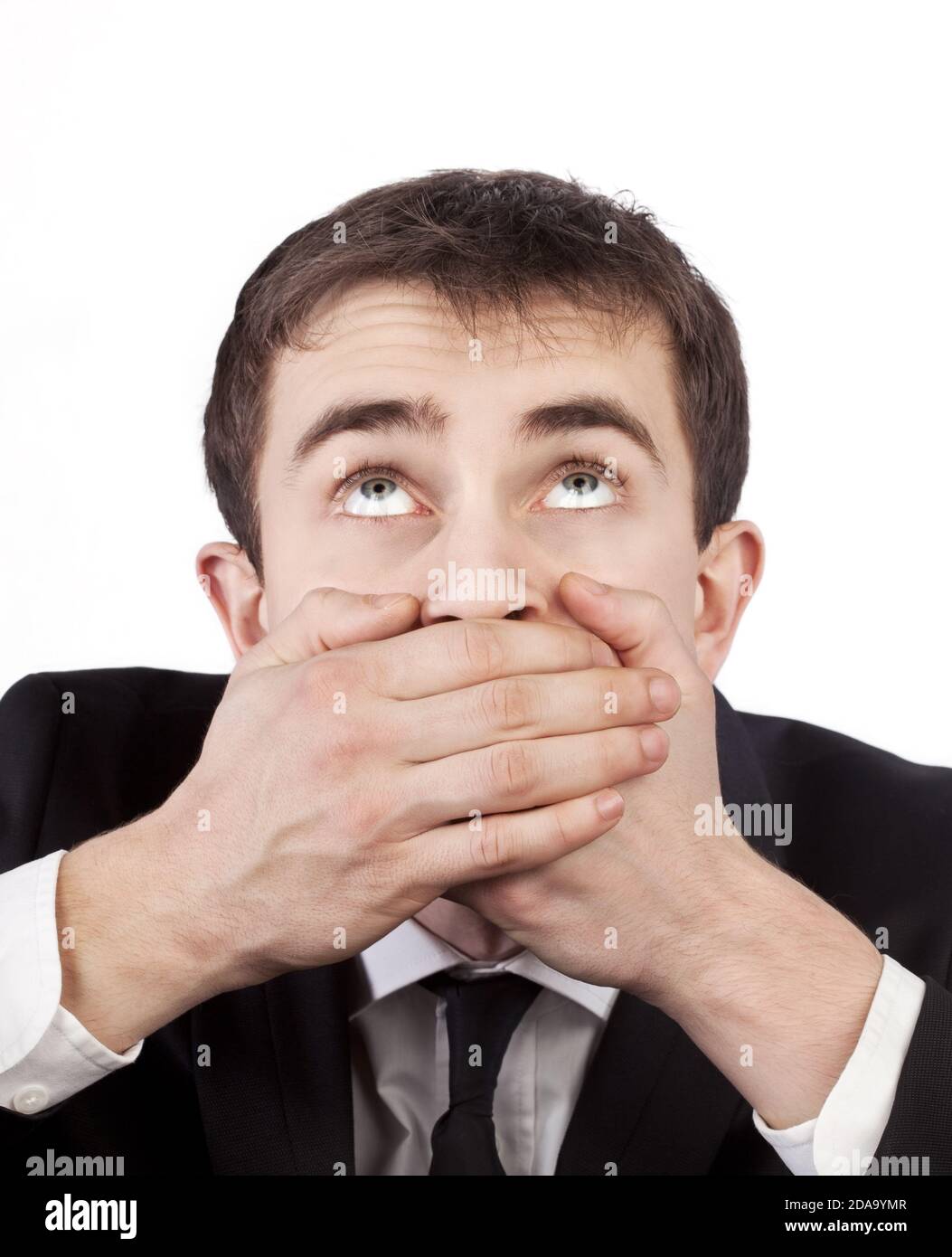 Silenced man in suite with hands across mouth Stock Photo - Alamy