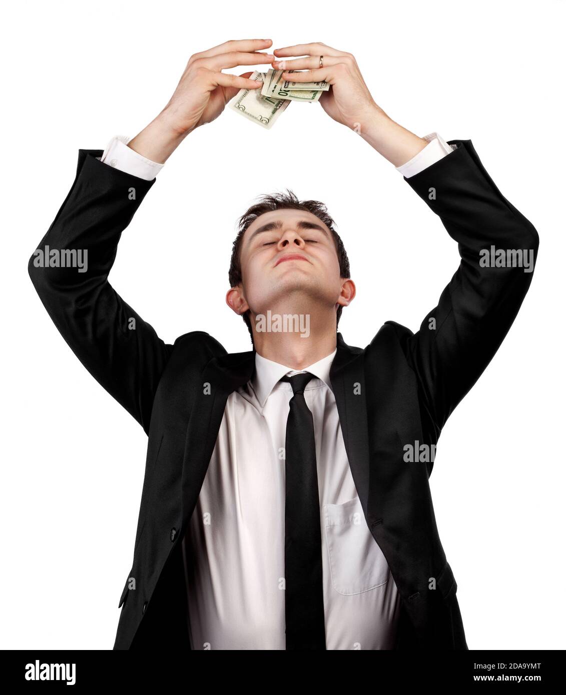 Young businessman holding dollar bills over his head. Isolated on white ...