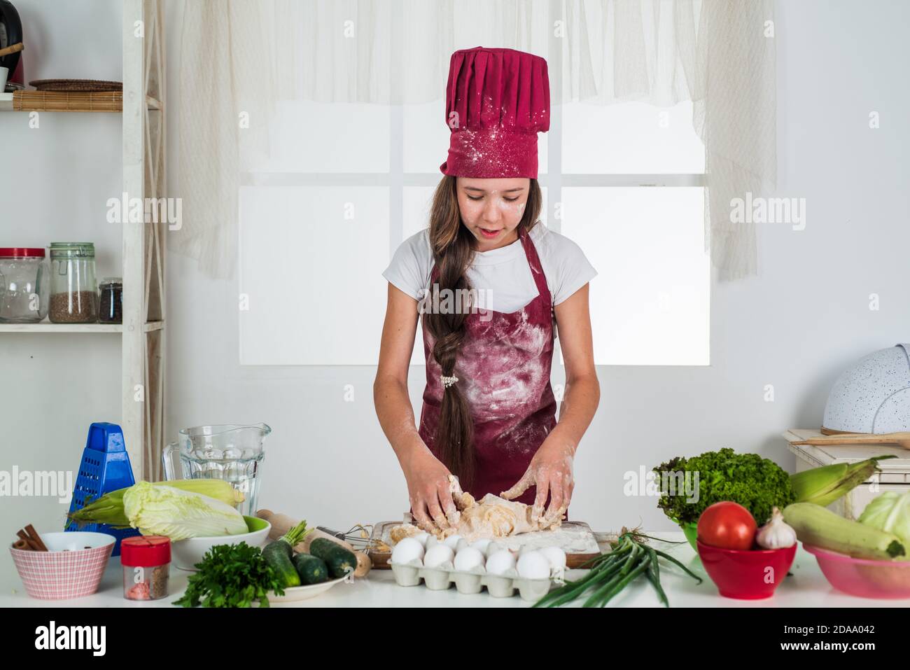 happy child wear cook uniform. chef girl in hat and apron. kid cooking ...