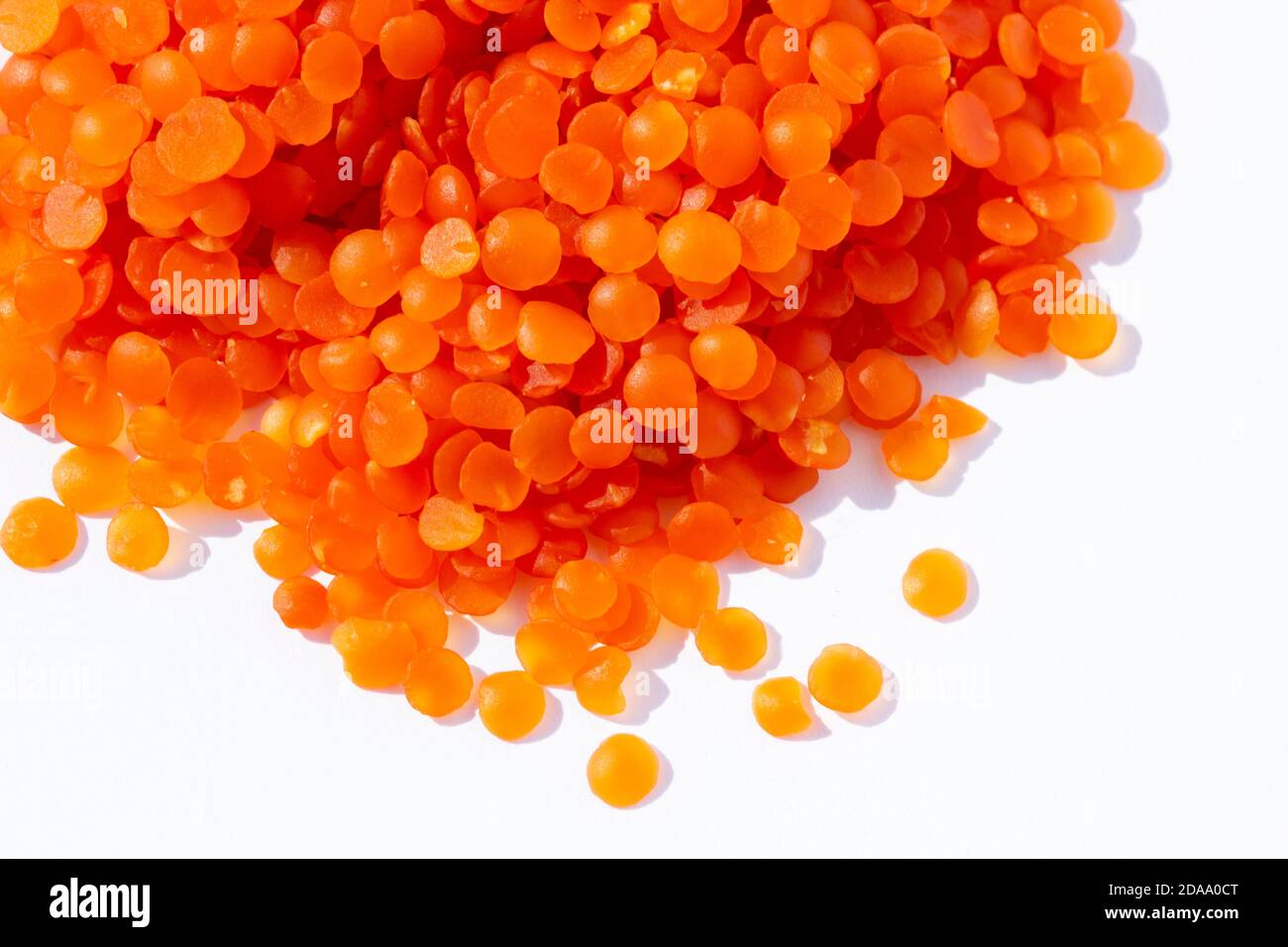 red lentil grains on a white background Stock Photo - Alamy