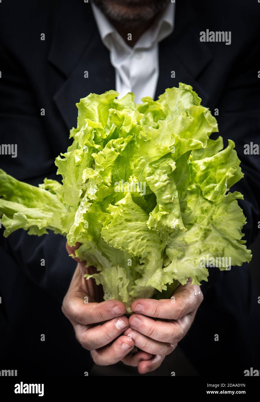 Healthy lifestyle and healthy eating concept. Man holding and eating ...