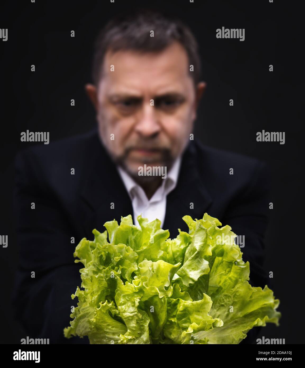Healthy lifestyle and healthy eating concept. Man holding and eating ...
