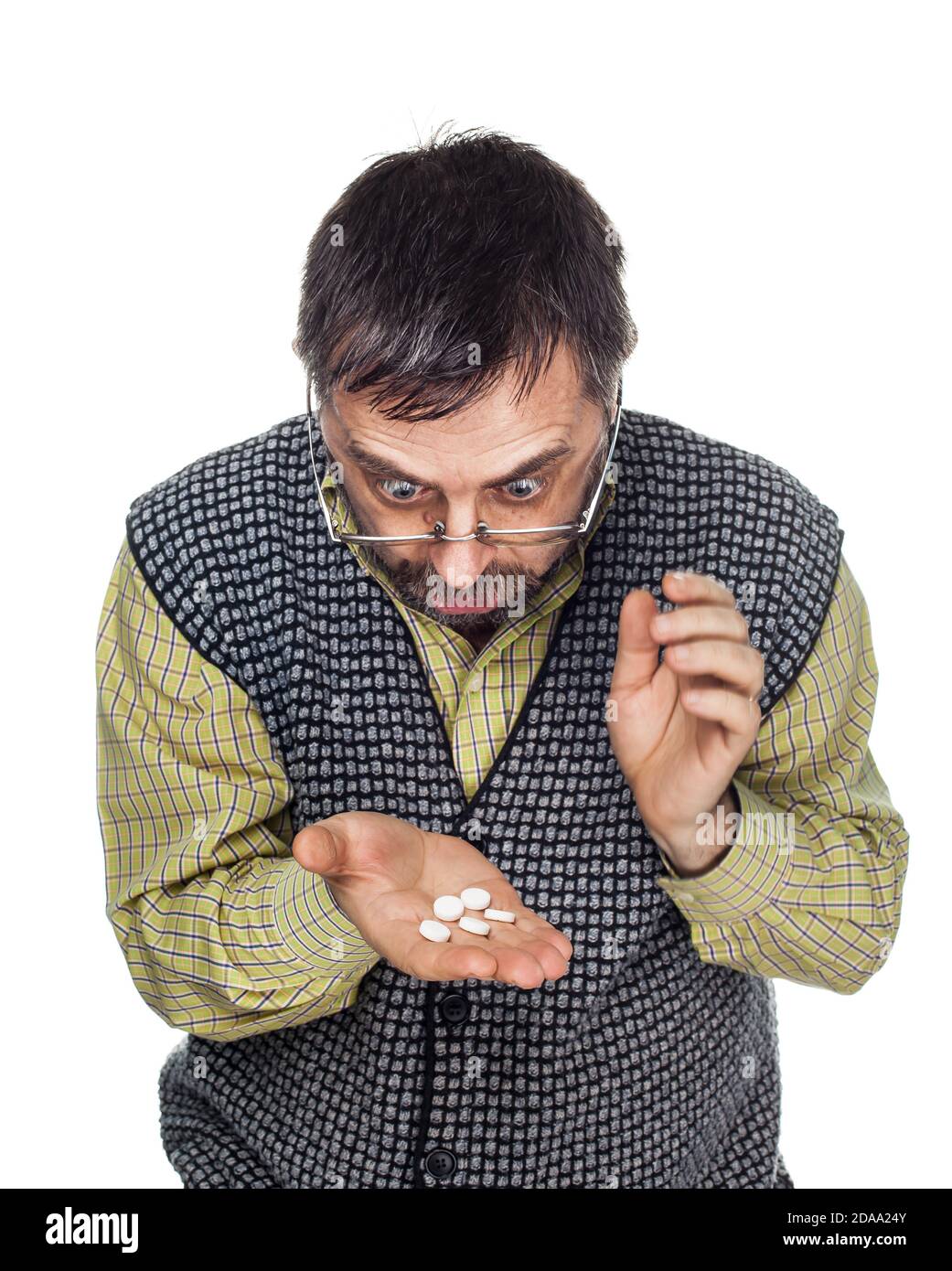 Medicine and health concept. Elderly man with pills in hands on a white ...